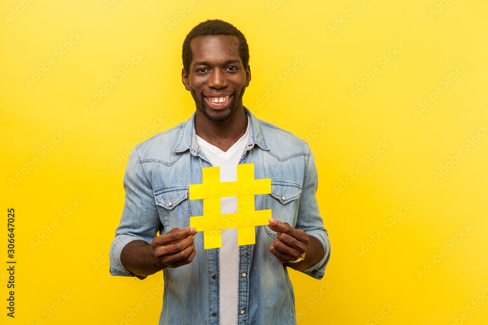 Viral hashtag. Portrait of positive man with attractive toothy smile in ...