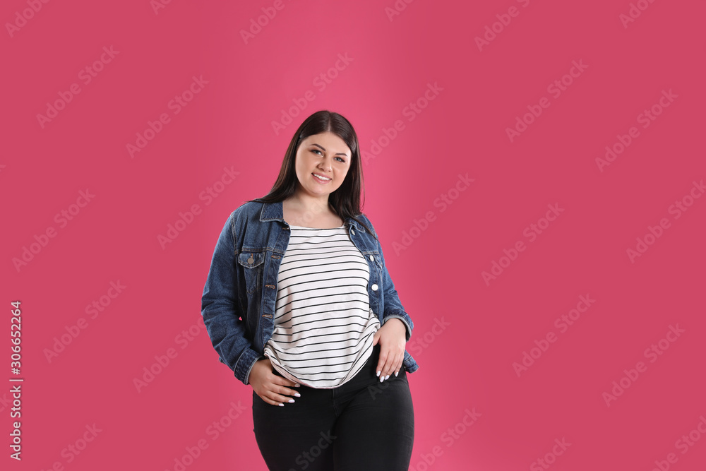 Beautiful overweight woman posing on pink background. Plus size model ...