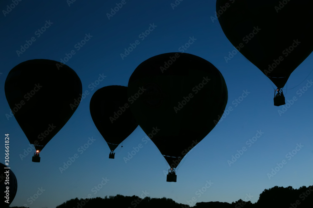 People in basket of hot air balloon in the background of sunset. Burner ...