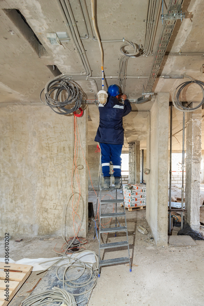 Drywall installation work in progress by construction workers at ...