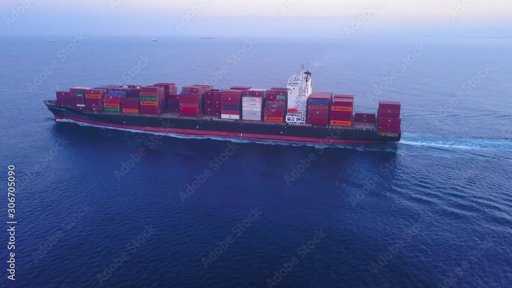 Large container ship at sea, loaded with various container brands. ULCV ...
