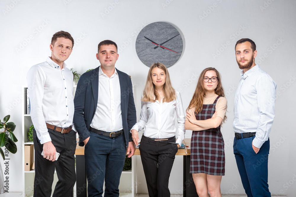 Smiling employees standing looking camera making team picture in office ...