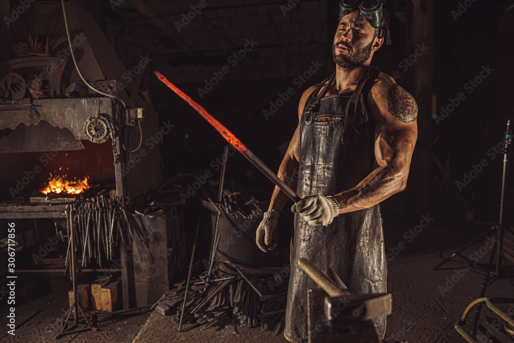 handsome muscular male blacksmith holding handmade metal for ...