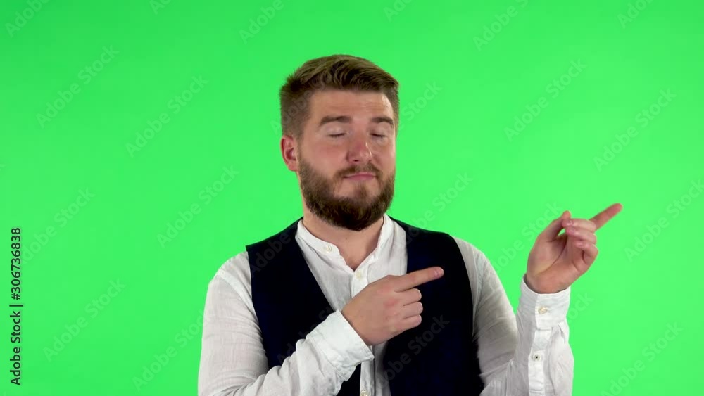 Man talking and pointing side hand for something, with copy space ...