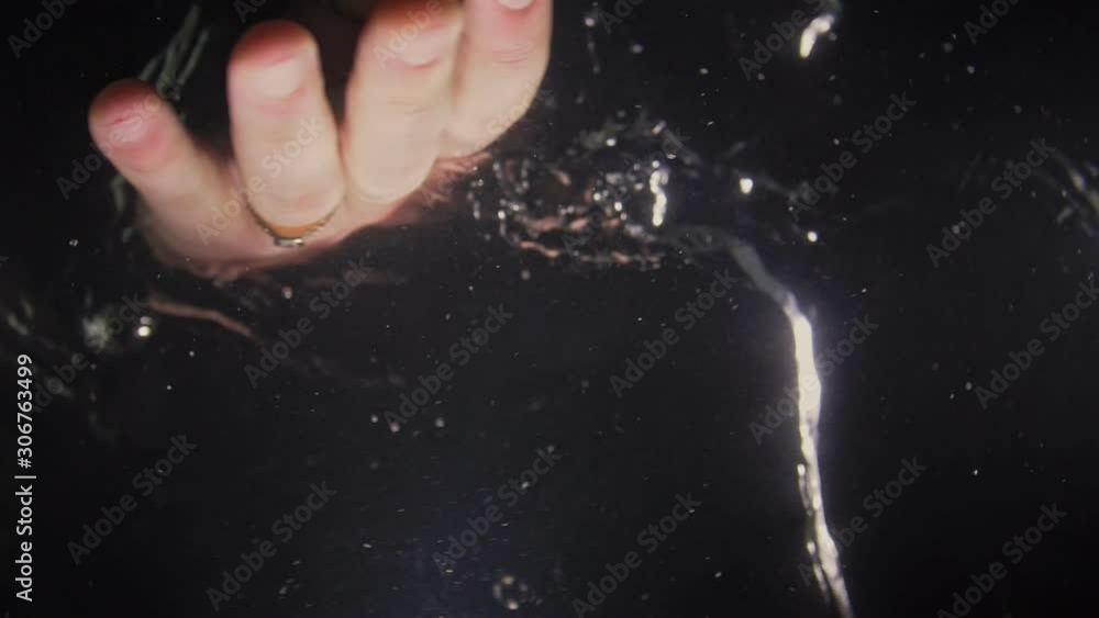 With the palm of your hand, check or mix the water. Bottom view from ...