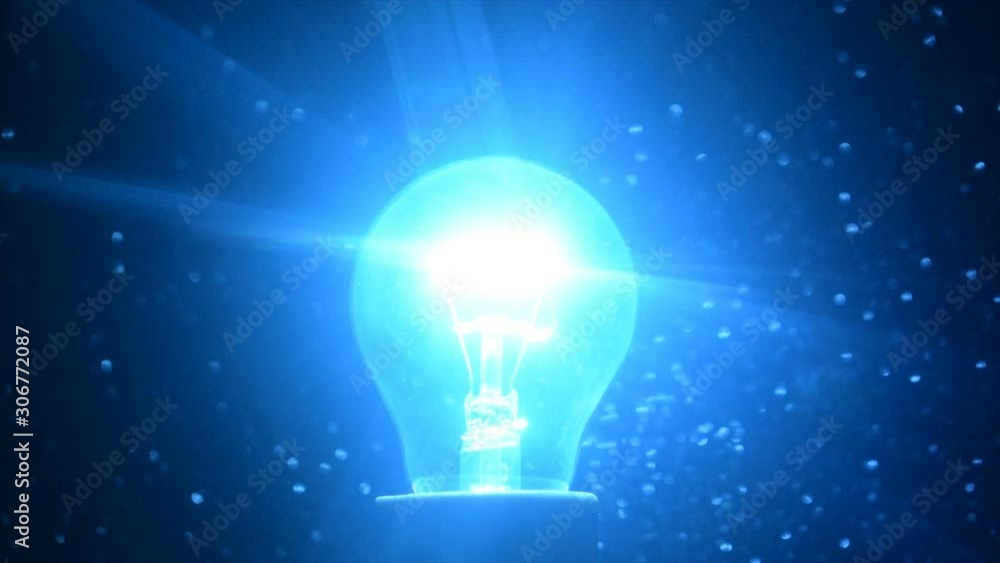 Macro shot of an illuminated light bulb. A close-up shows a lamp that ...