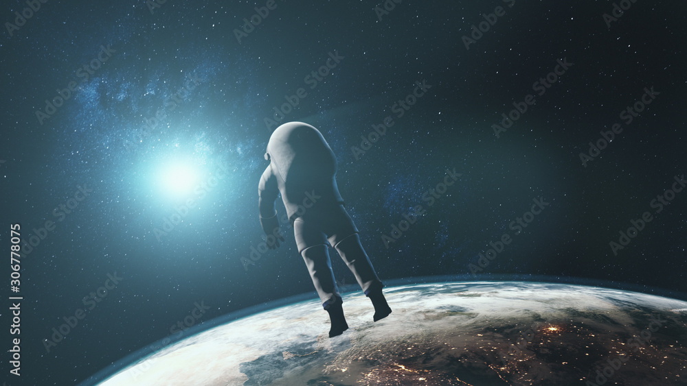 Astronaut against realistic planet Earth starlight. Back view of ...
