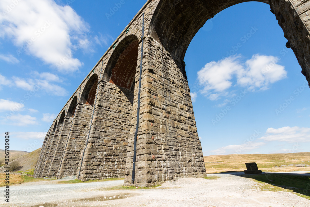 Towering sunlit arches of a railway viaduct, wide angle Stock Photo ...