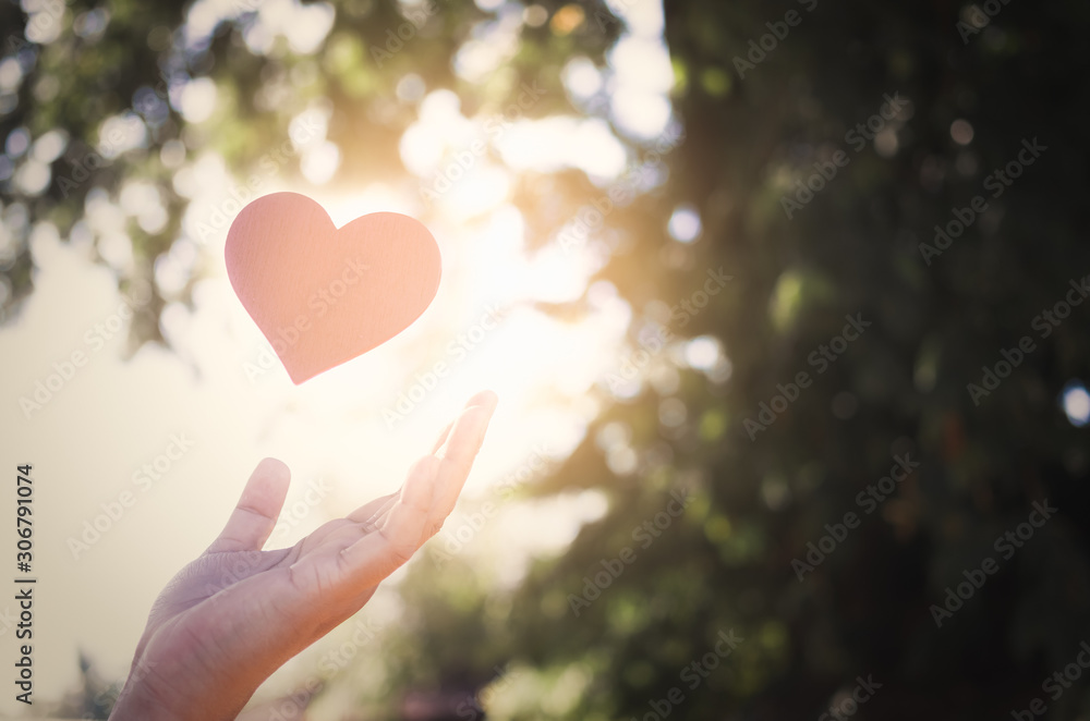 pink heart shaped bubble floating above human plam Stock Photo | Adobe ...
