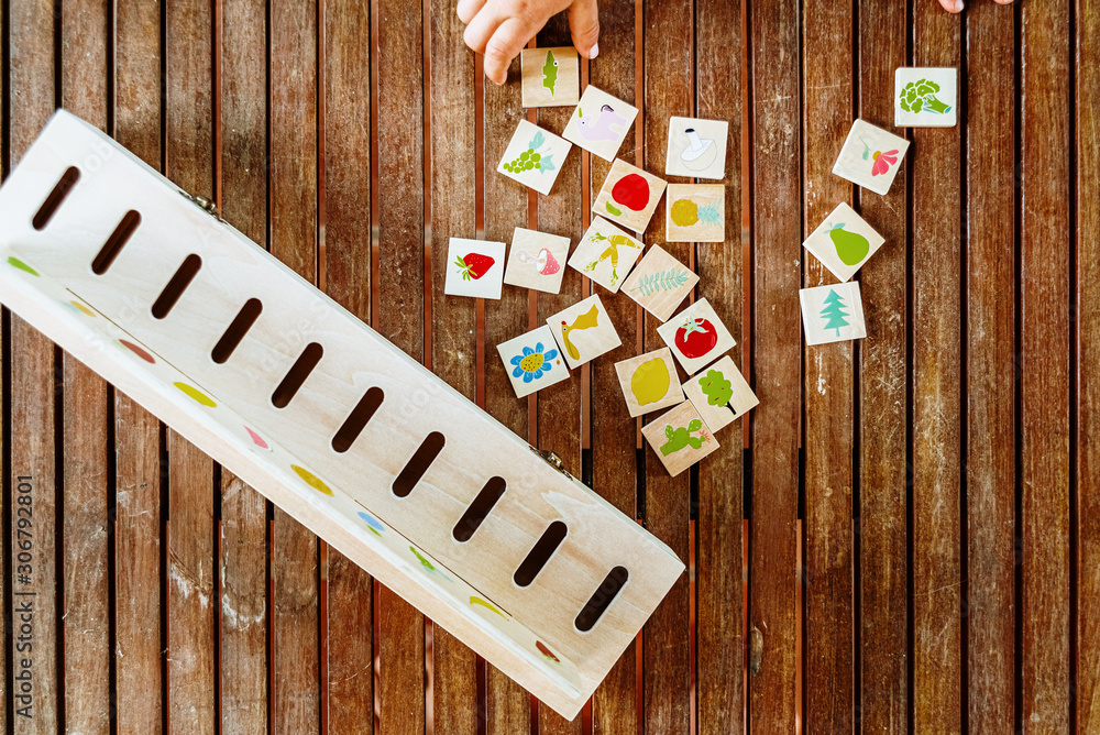 Child having fun with an educational wooden game at school, to make ...
