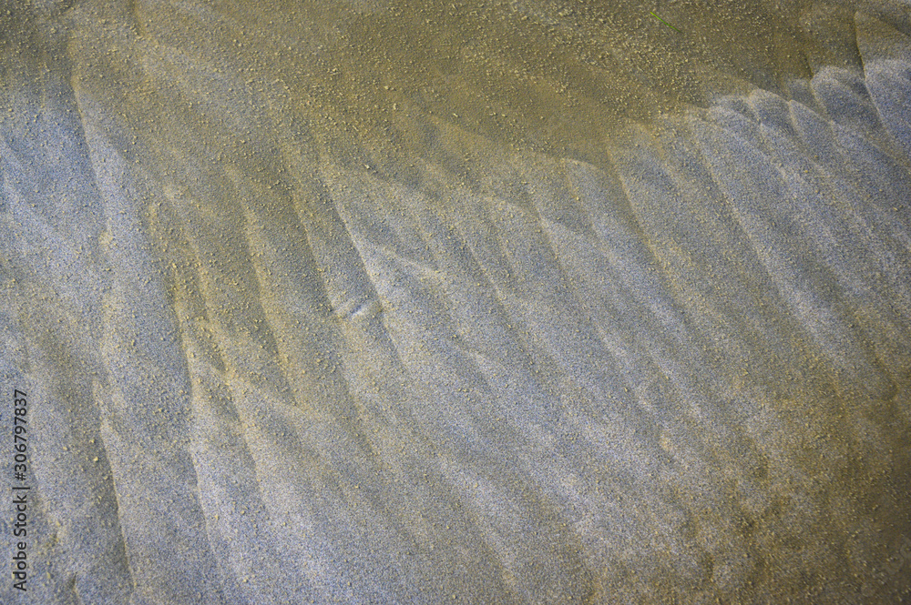 Pattern and texture in the wet sand and water as a nature background ...