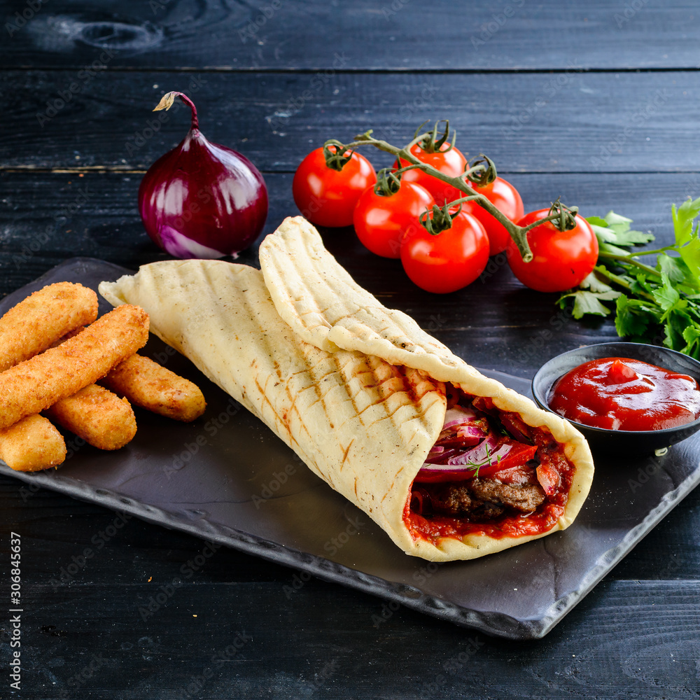 Doner kebab (shawarma or doner wrap). Grilled chicken on lavash (pita ...