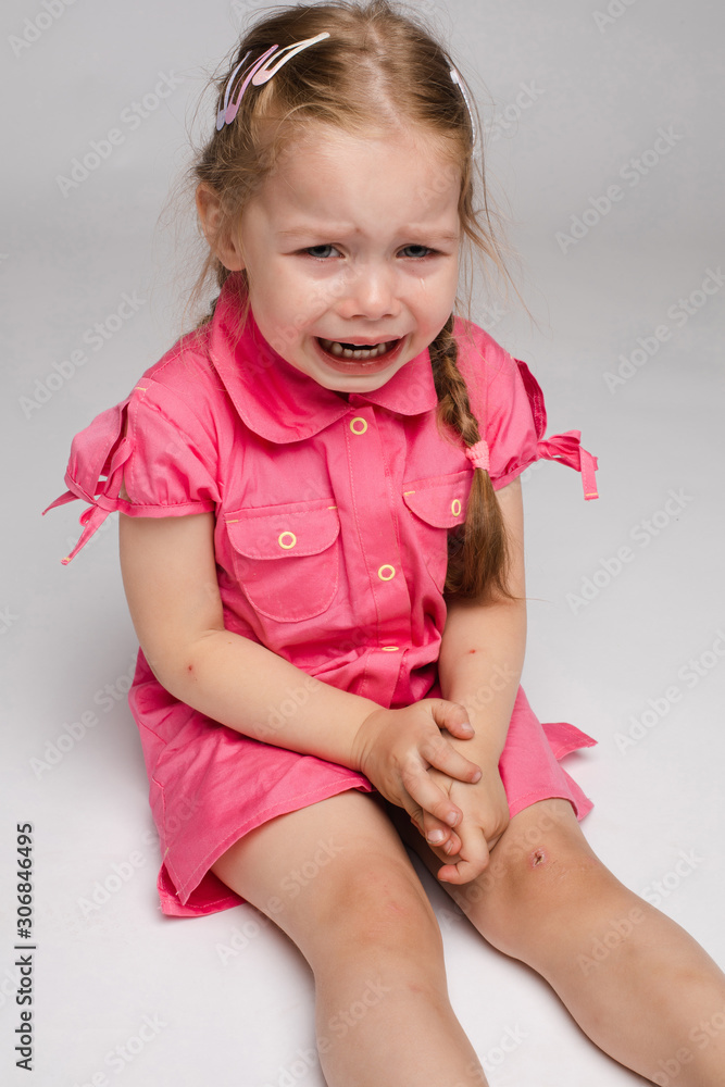 Stock photo of sweet little girl with braids in pink dress crying while ...