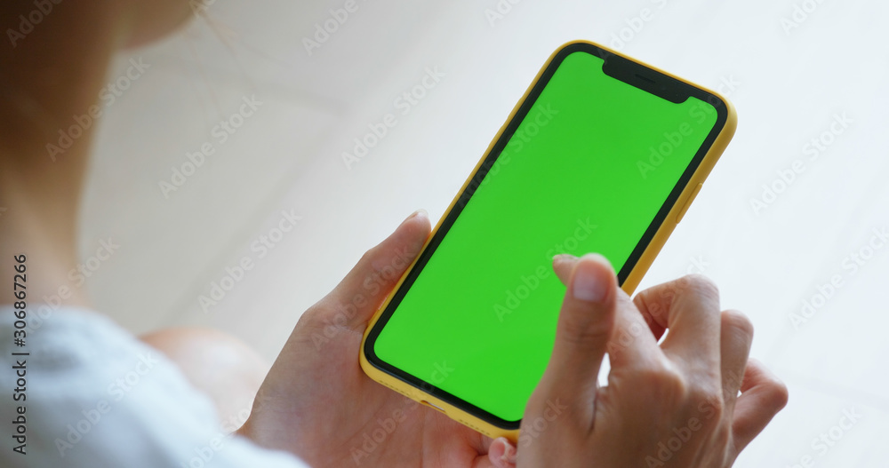 Woman use of cellphone with green screen at home Stock Photo | Adobe Stock