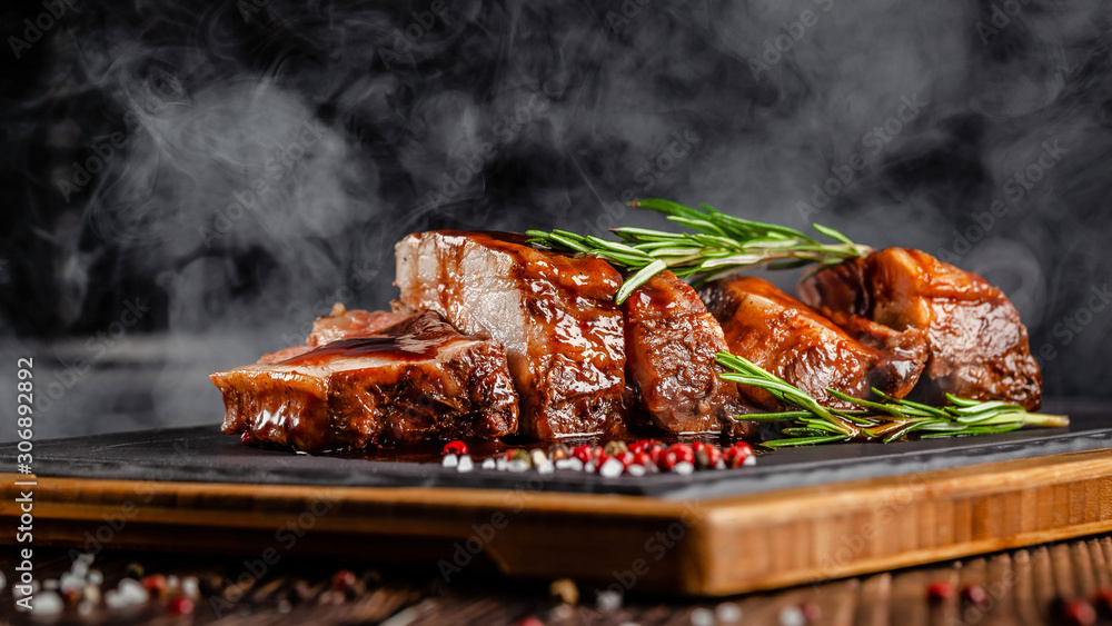 American food concept. Grilled pork ribs with grilled sauce, with smoke ...