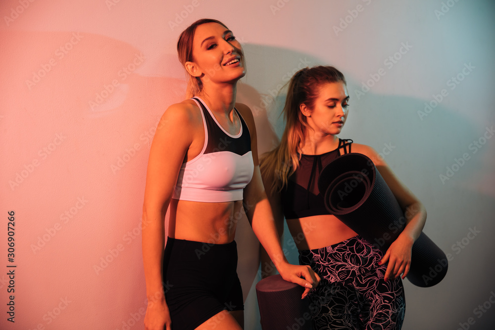 On a white background posing in a sports hall,Young sports girls are ...