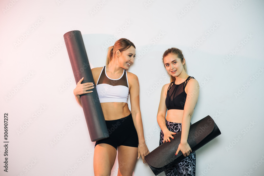 On a white background posing in a sports hall,Young sports girls are ...