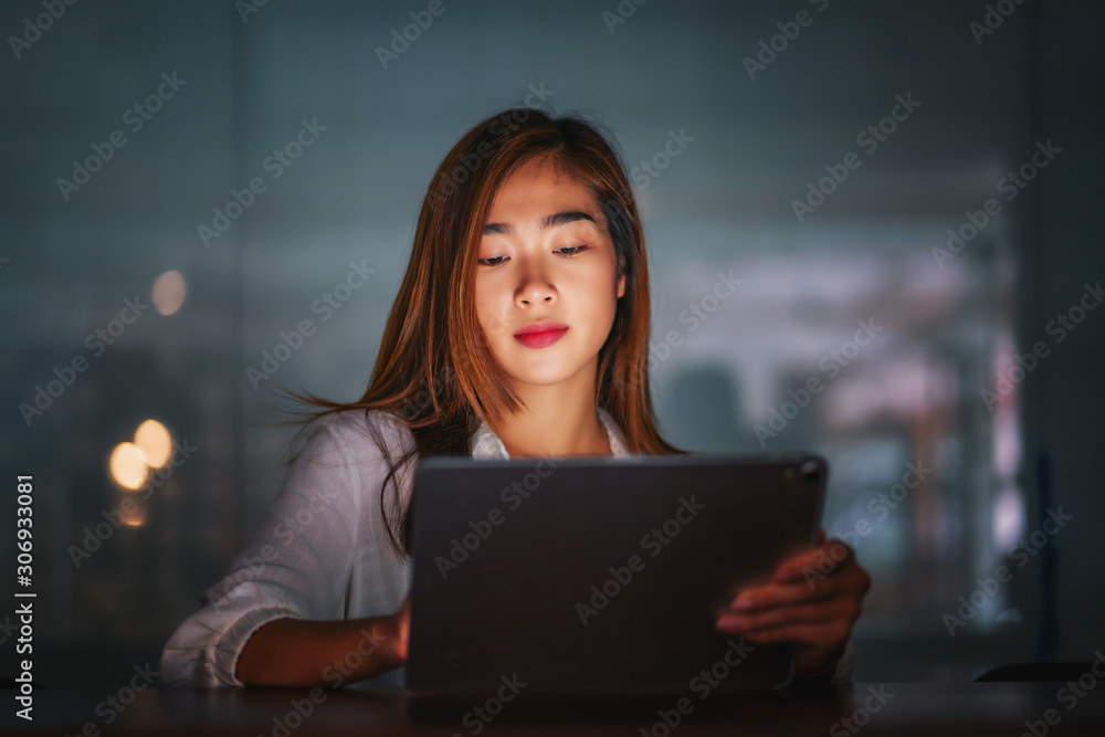 Young asian woman using a digital tablet at night in the room. Stock ...