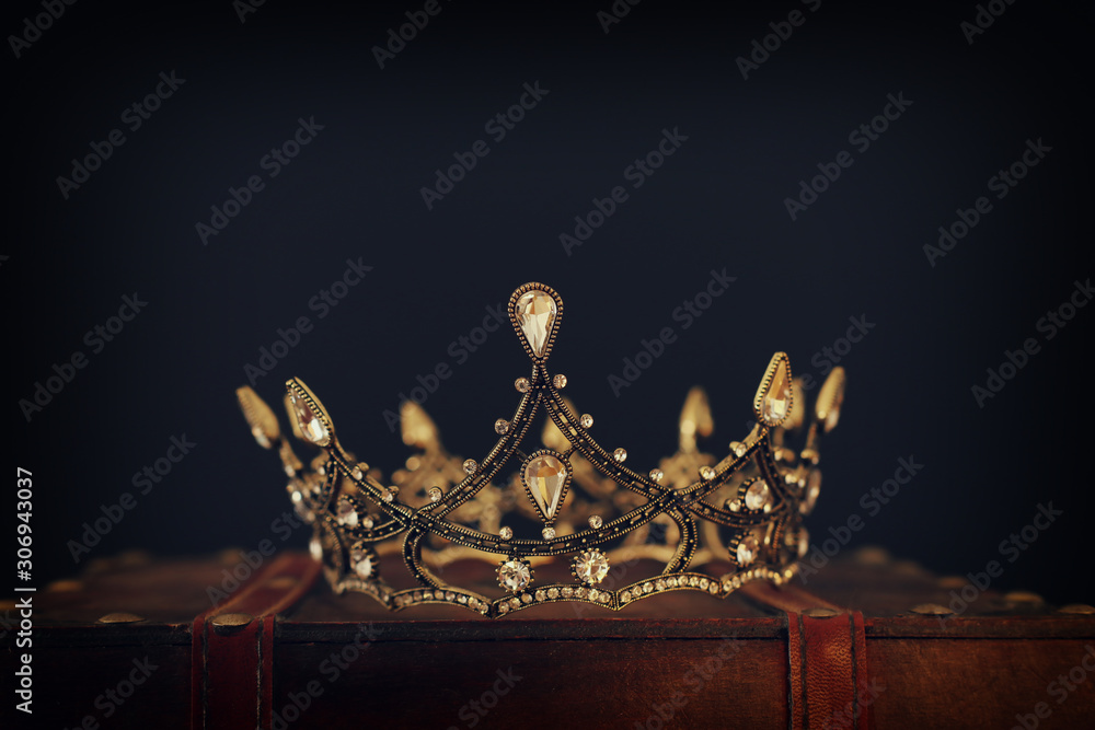 low key image of beautiful queen/king crown over wooden table. vintage ...