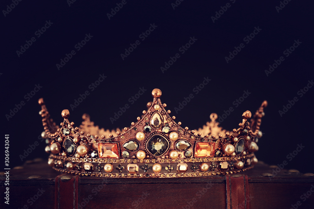 low key image of beautiful queen/king crown over wooden table. vintage ...