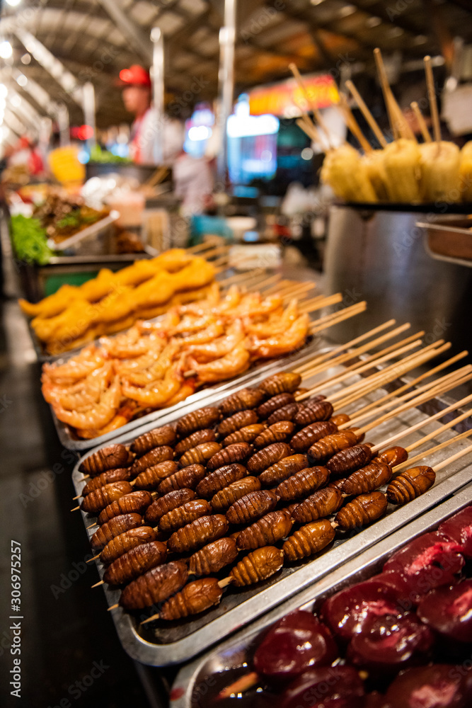 Grill and fried silkworm pupae in a food market in Beijing, China ...