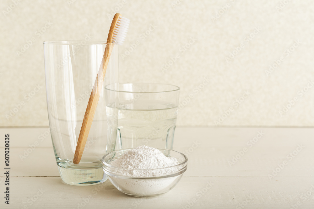 Bamboo toothbrushes, glass of water, dentifrice tooth powder on white ...
