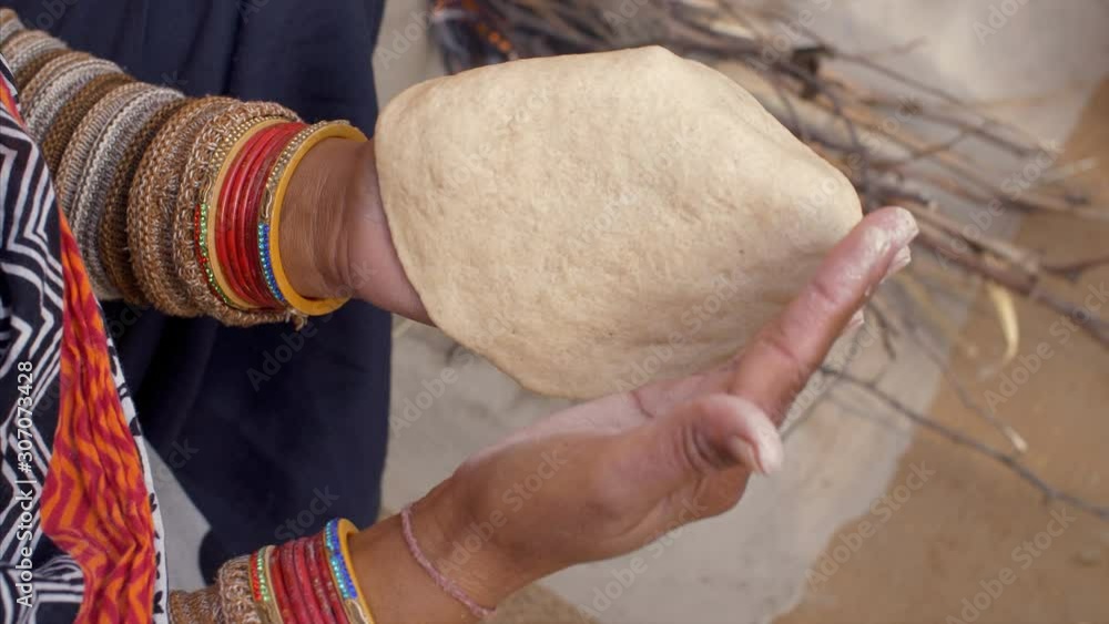 Close shot an Indian woman making chapati with hands. Indian stock ...