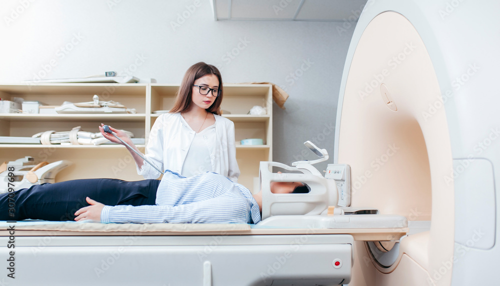 Radiologic model technician smiling help at mature female patient lying ...