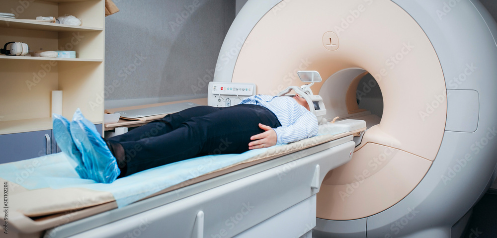 Female patient undergoing MRI - Magnetic resonance imaging in Hospital ...