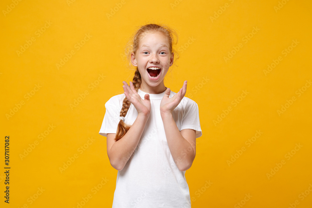 Excited little ginger kid girl 12-13 years old in white t-shirt ...