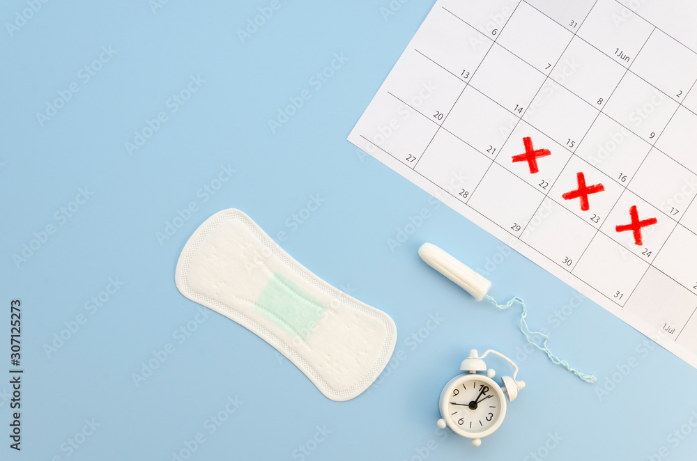 Flat lay female cycle calendar with menstrual pad, tampon and white ...