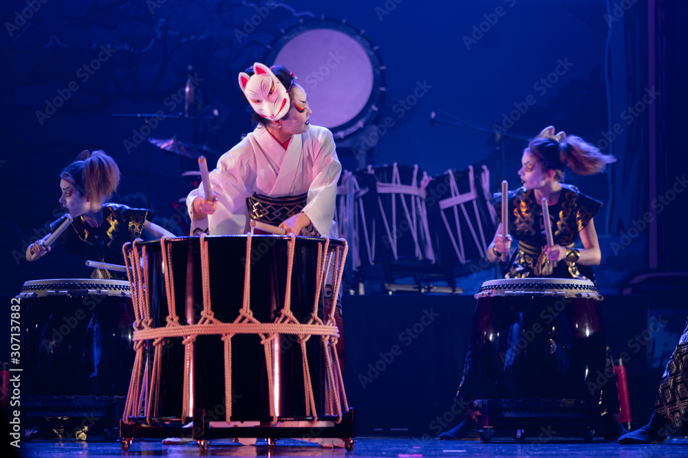 Traditional Japanese performance. Group of actresses drum taiko drums ...