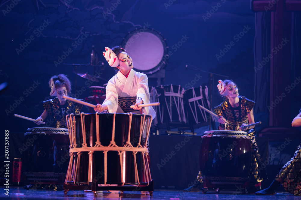 Traditional Japanese performance. Group of actresses drum taiko drums ...