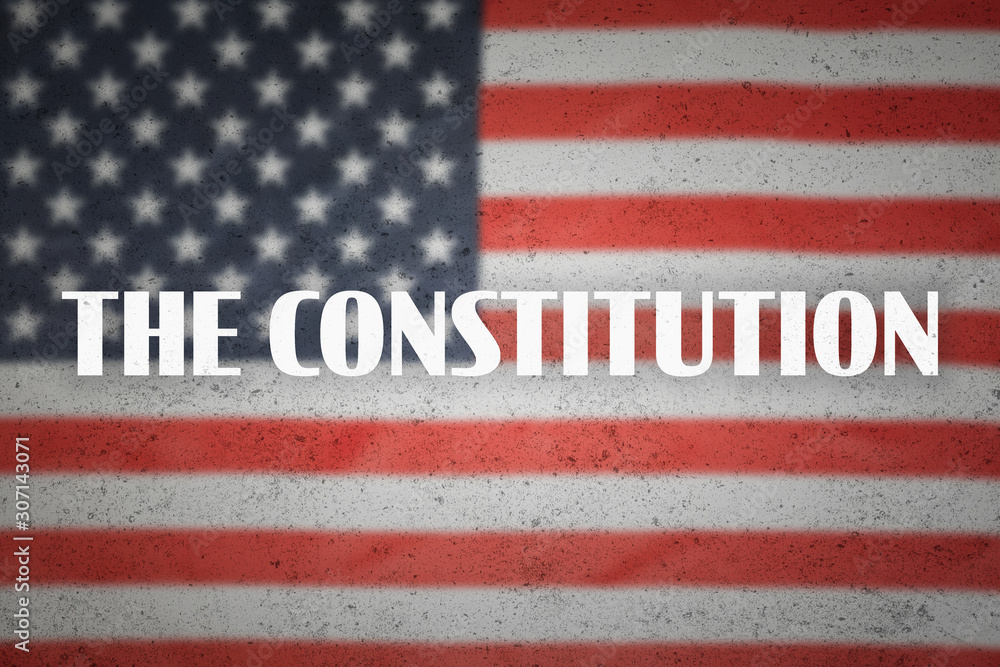 Word "The Constitution" on blurred American flag. USA themed political ...