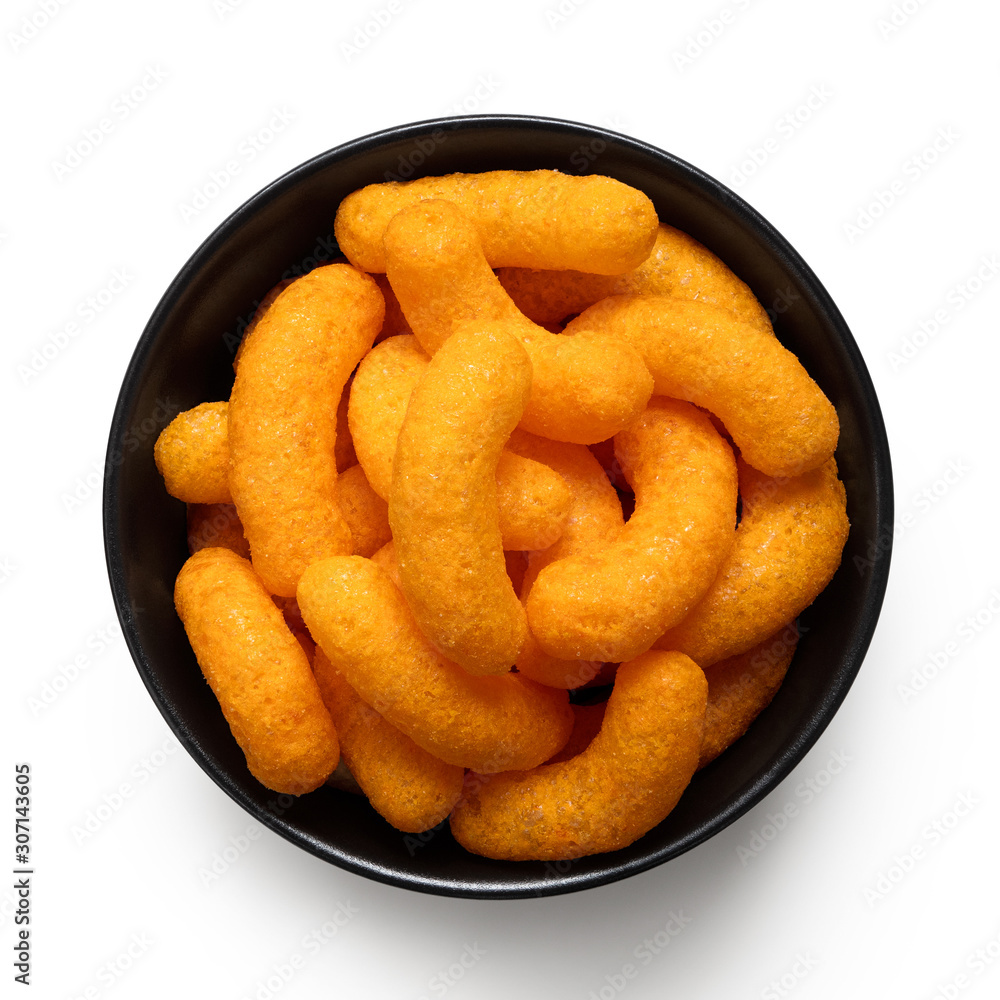 Extruded cheese puffs in a black ceramic bowl isolated on white. Top ...