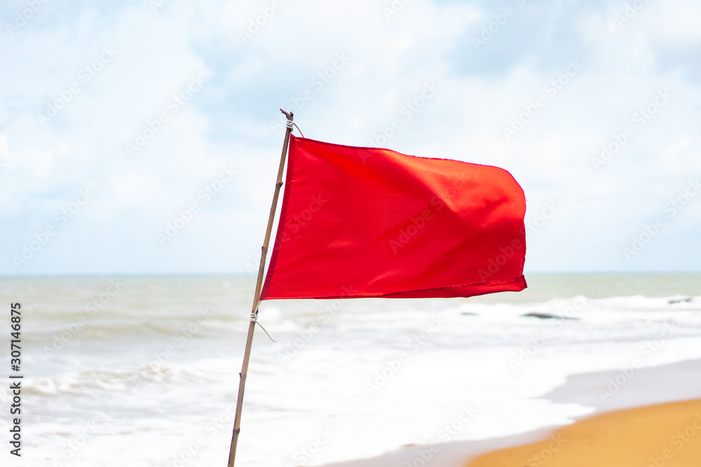 No swimming here red flag on the beach, A no swimming danger sign at ...