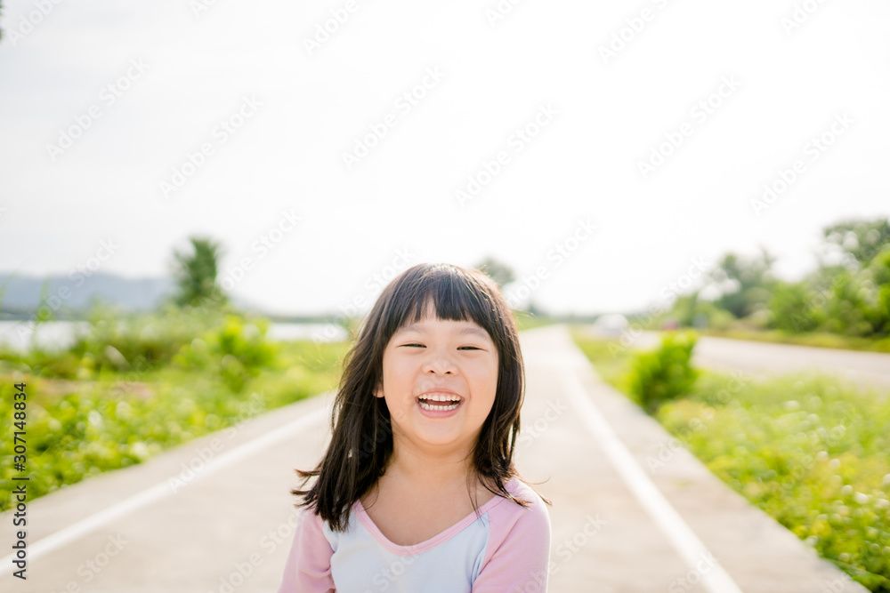 Stockfoto med beskrivningen Happy Little asian girl child showing front ...