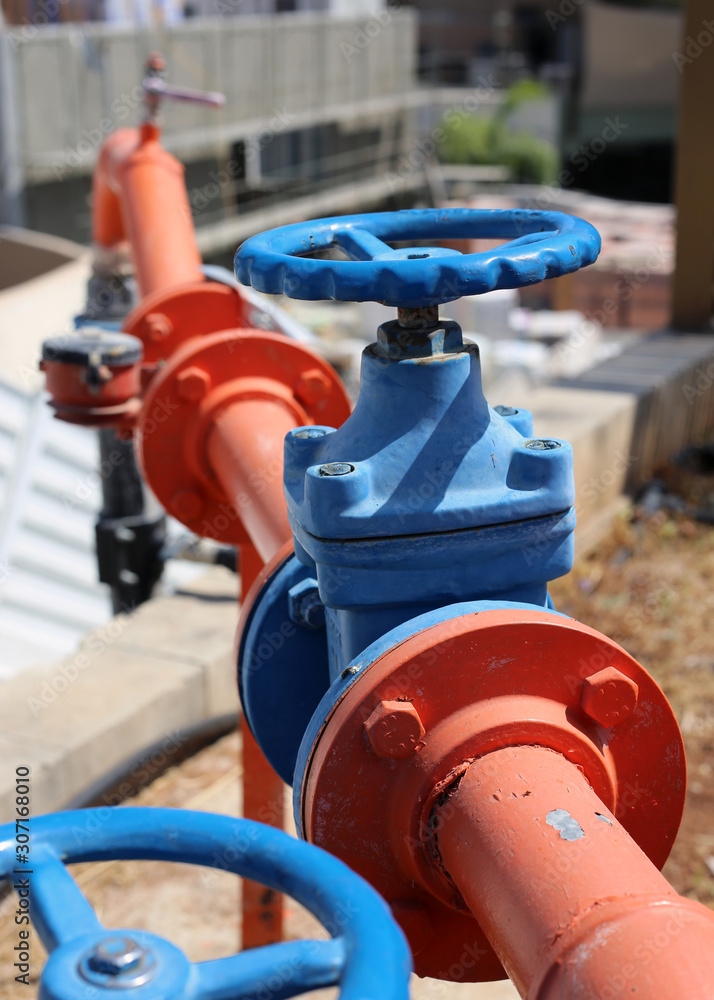 Orange and blue colorful orange and blue water pipes with big vents. In ...