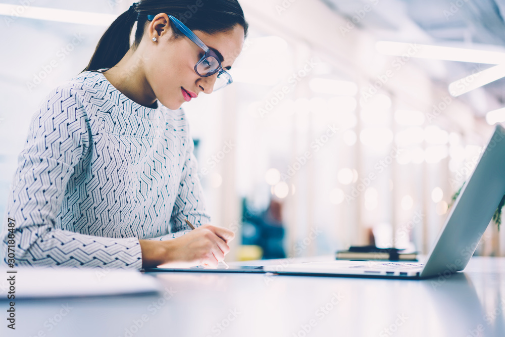 Skilled female web designer drawing using digital tablet and ...