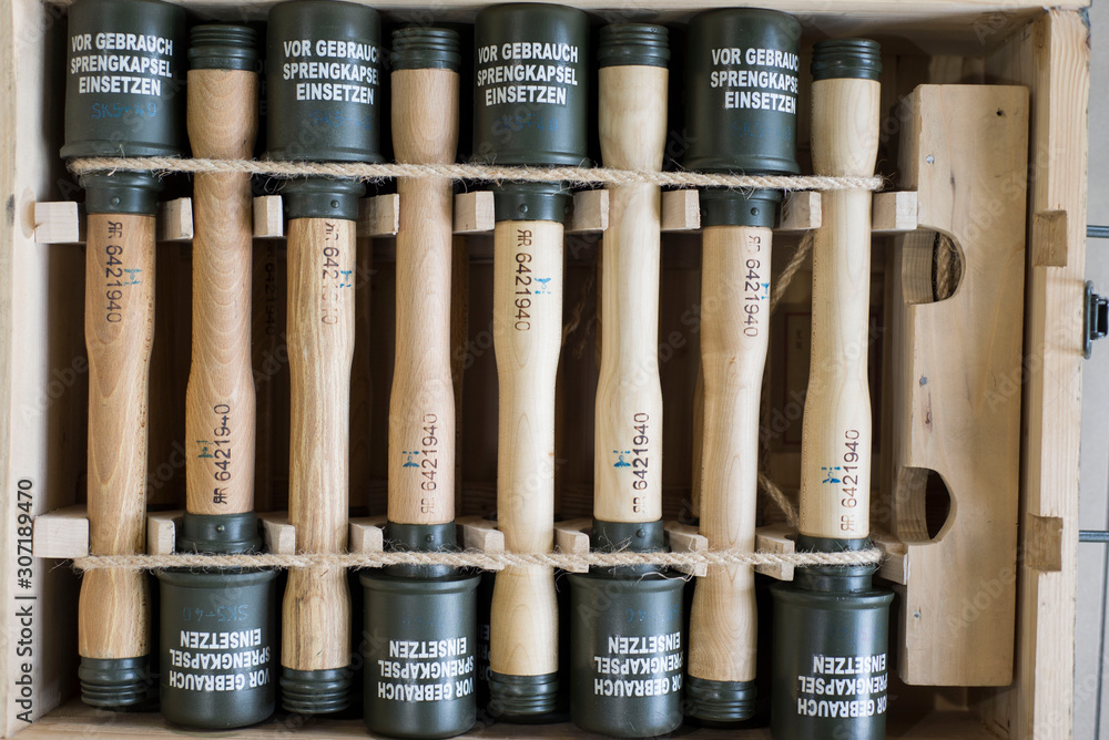 World War II fragmentation grenades stacked in a military box. Gun shop ...