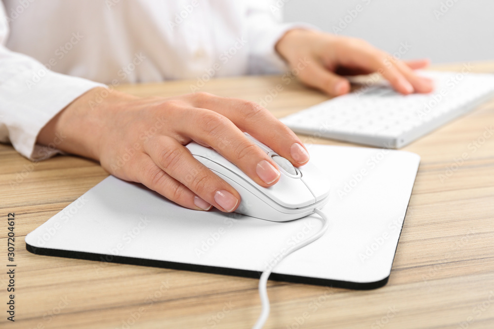 Woman using modern wired optical mouse at office table, closeup Stock ...