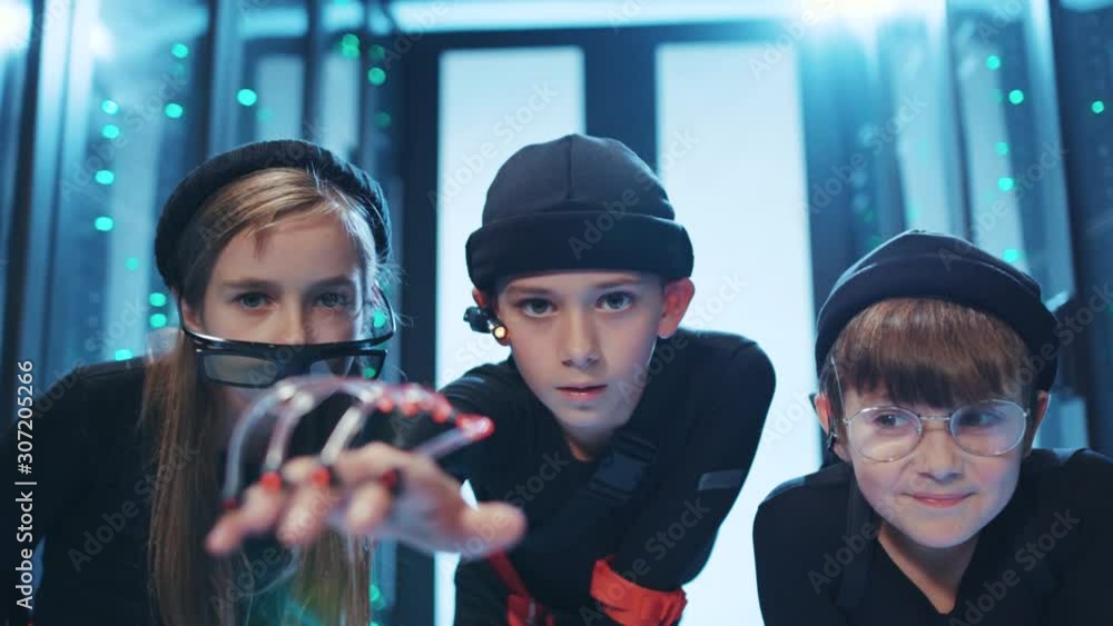 Young hackers kids sneaking in future server room, using exoskeleton ...