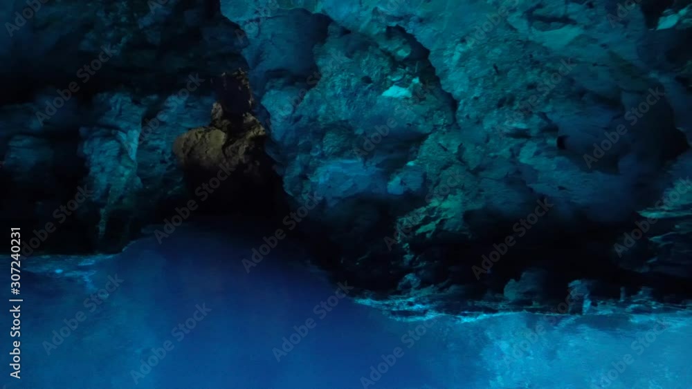 Close up view of rock walls and glowing blue water inside the famous ...