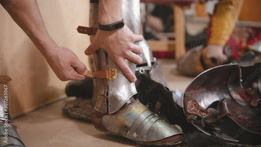 A man putting on an armour for the knights battle training - put on a ...