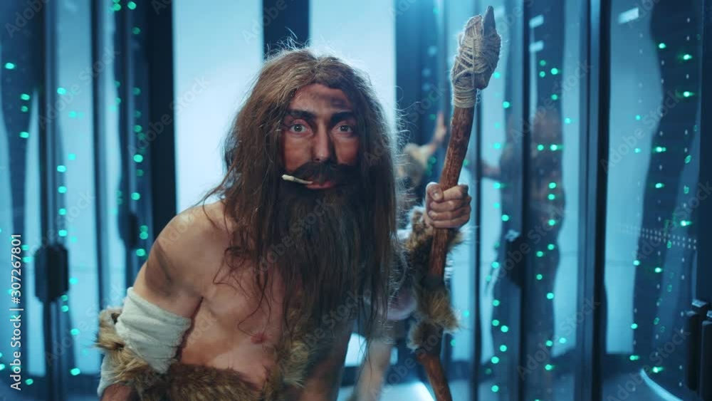 Wild caveman of neanderthals tribe chewing animal bone holding a stone ...