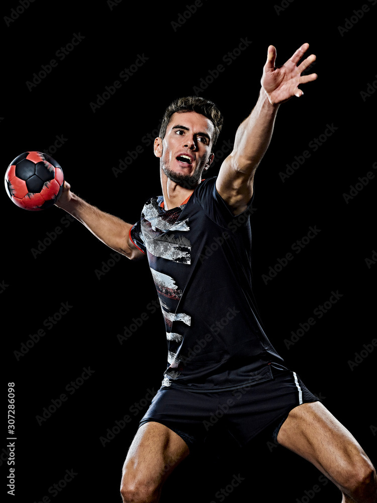 one caucasian young handball player man in studio isolated on black ...