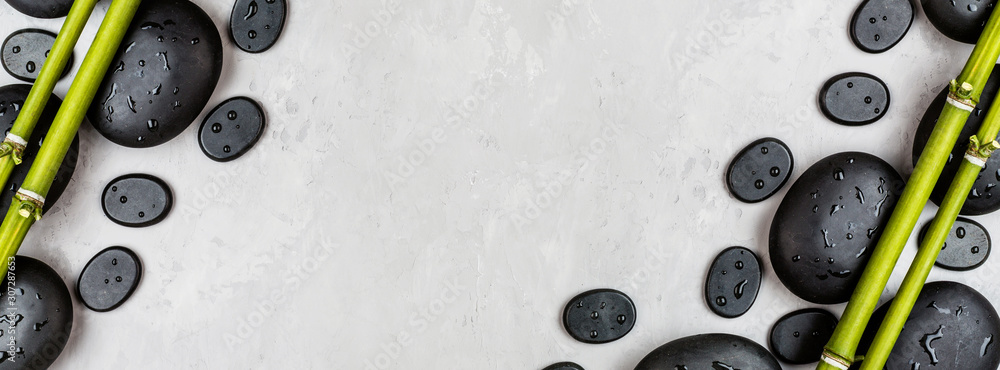 Top view of hot spa stones set for massage treatment on gray concrete ...