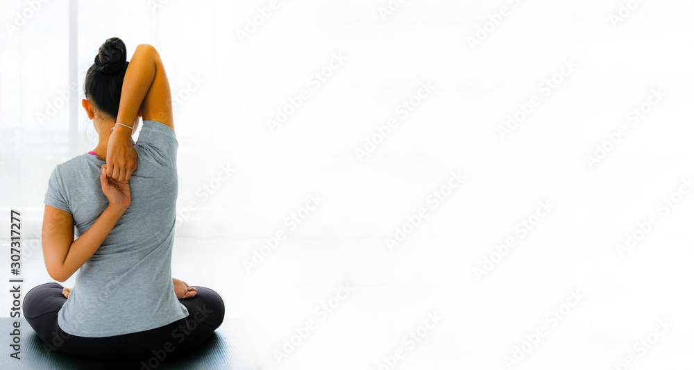 female doing stretching exercises yoga Hands behind back, sitting in ...