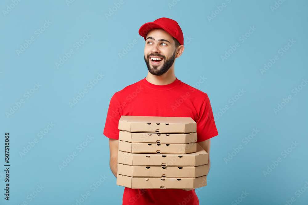 Delivery man in red workwear giving food order pizza boxes isolated on ...