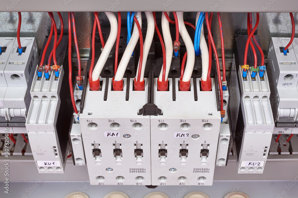Electrical cables and wires are connected from the top to the ...